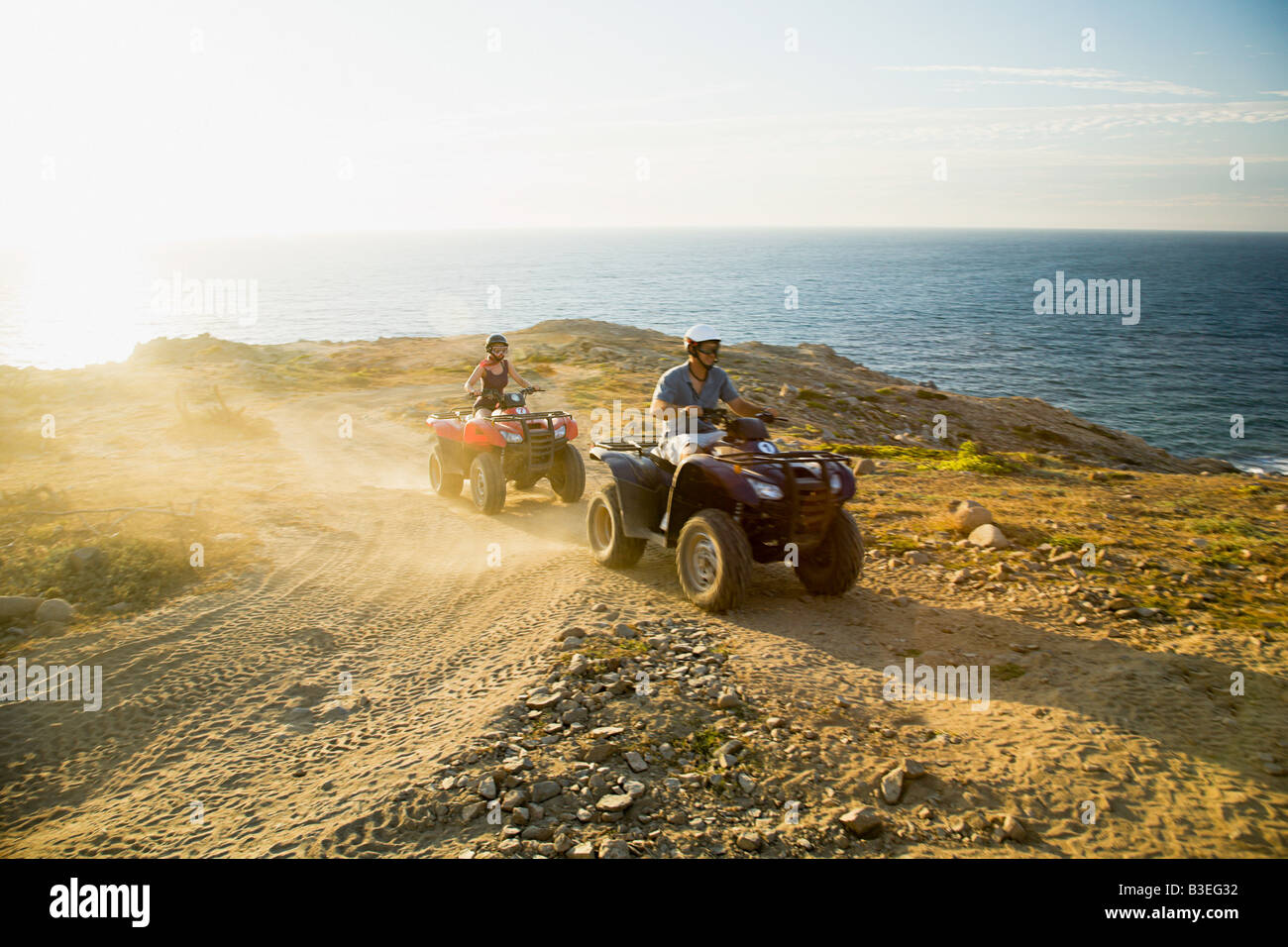 People riding all terrain vehicles Stock Photo - Alamy