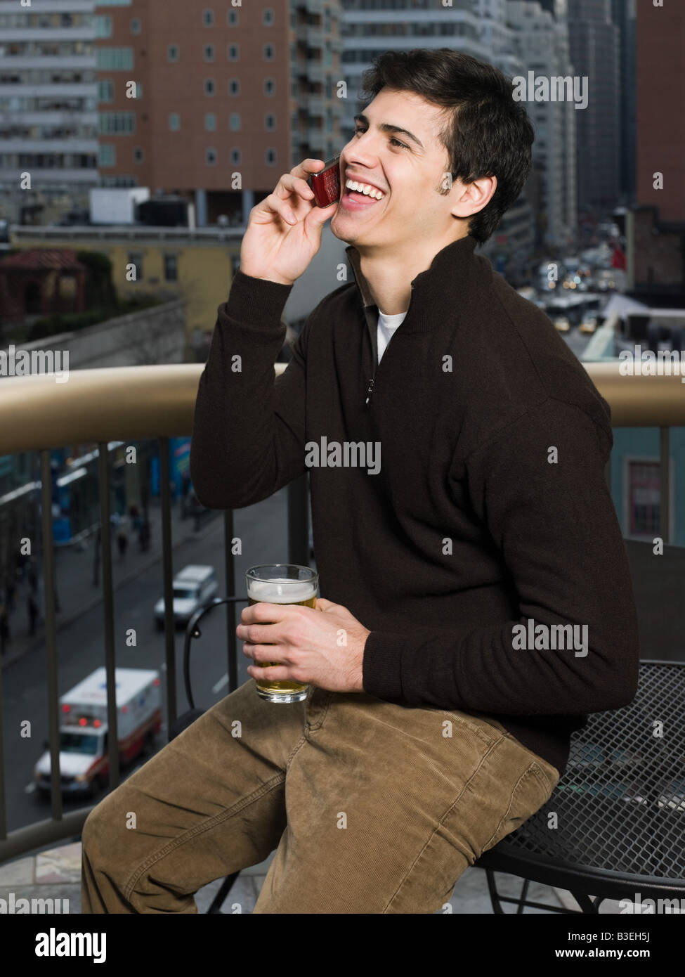 Man with cellphone and beer Stock Photo - Alamy