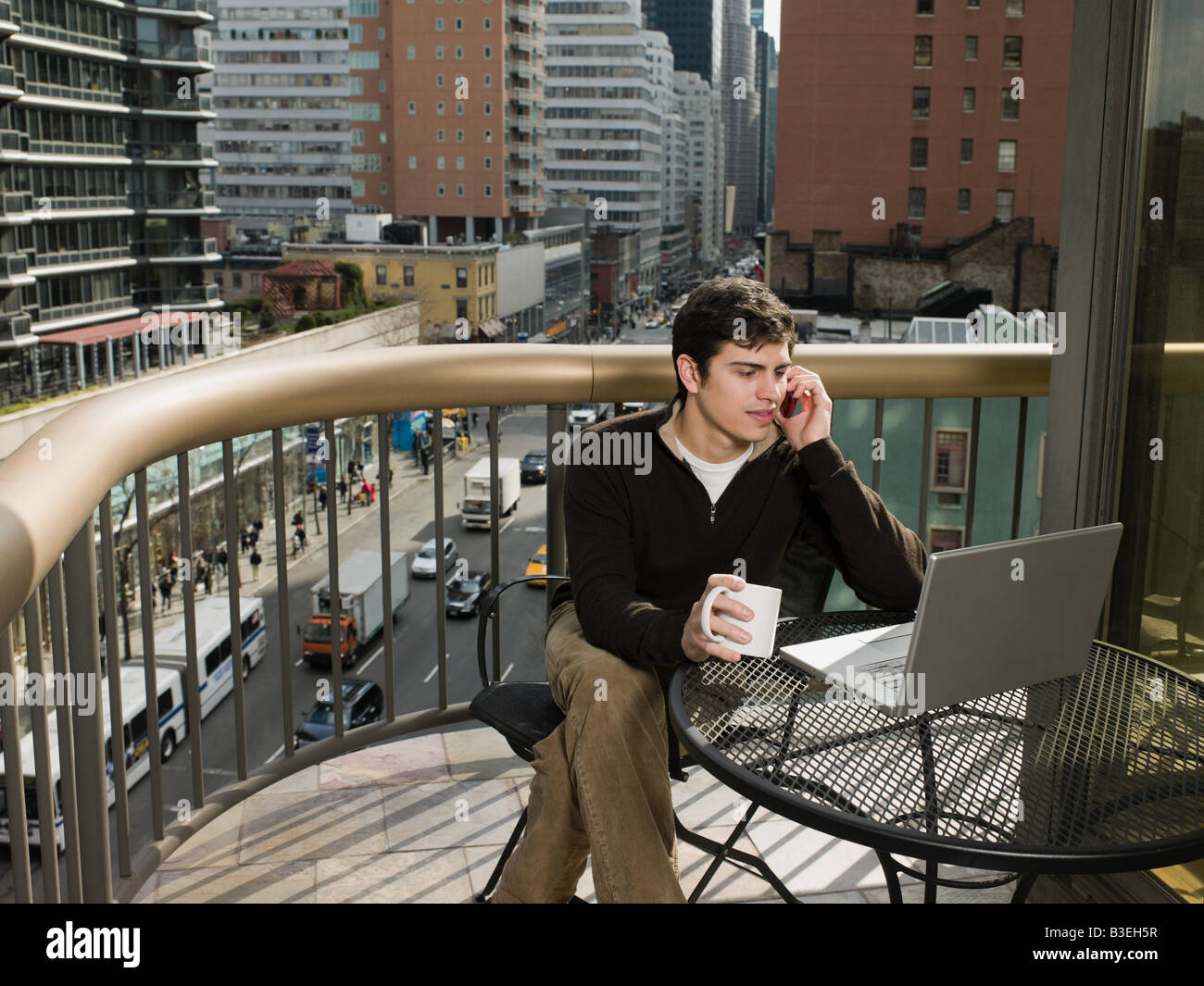 Man sitting on balcony railing hi-res stock photography and images - Alamy