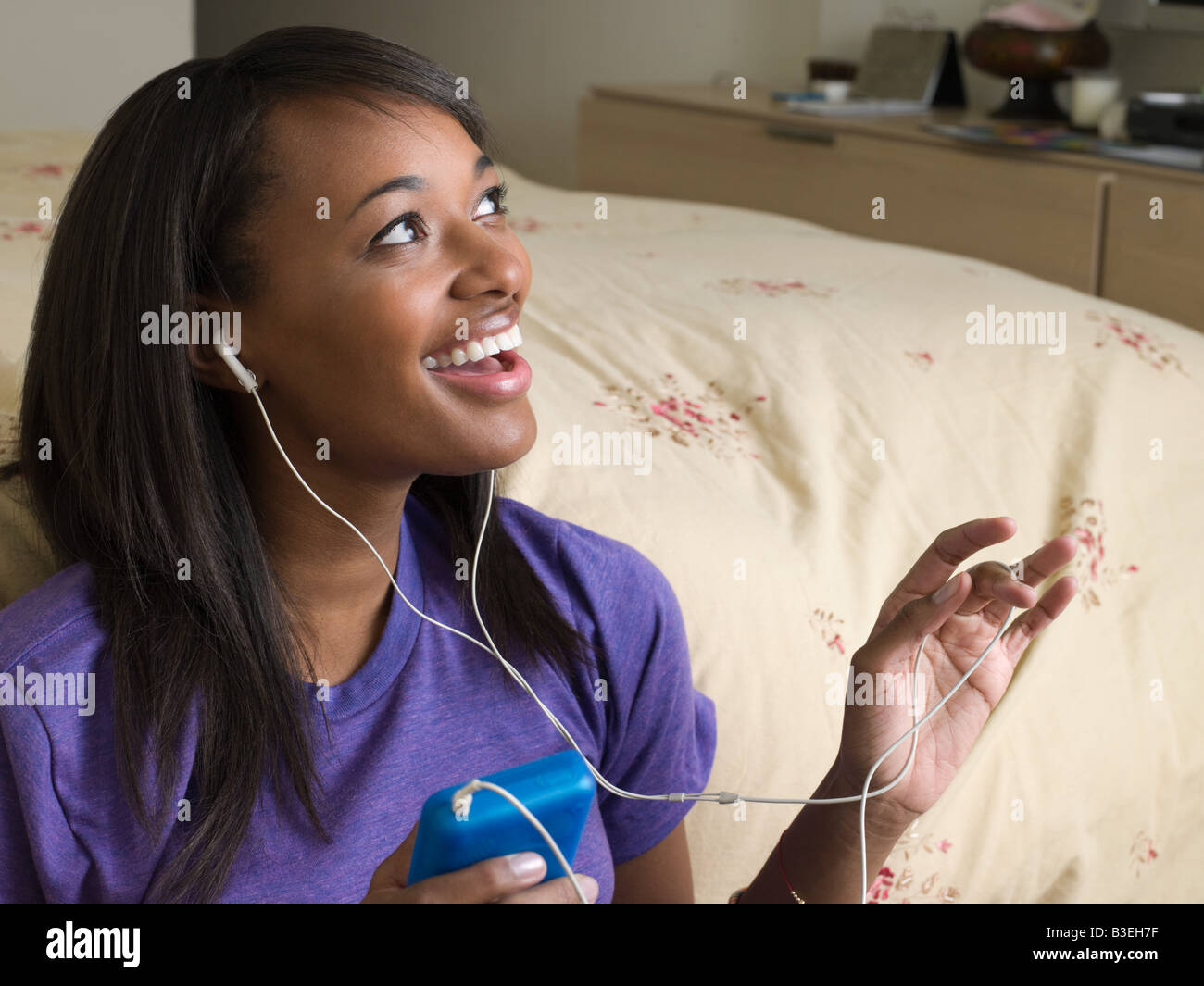 Happy woman with mp3 player Stock Photo - Alamy