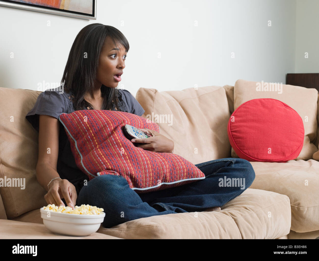 Woman only watching tv and eating hi-res stock photography and images ...