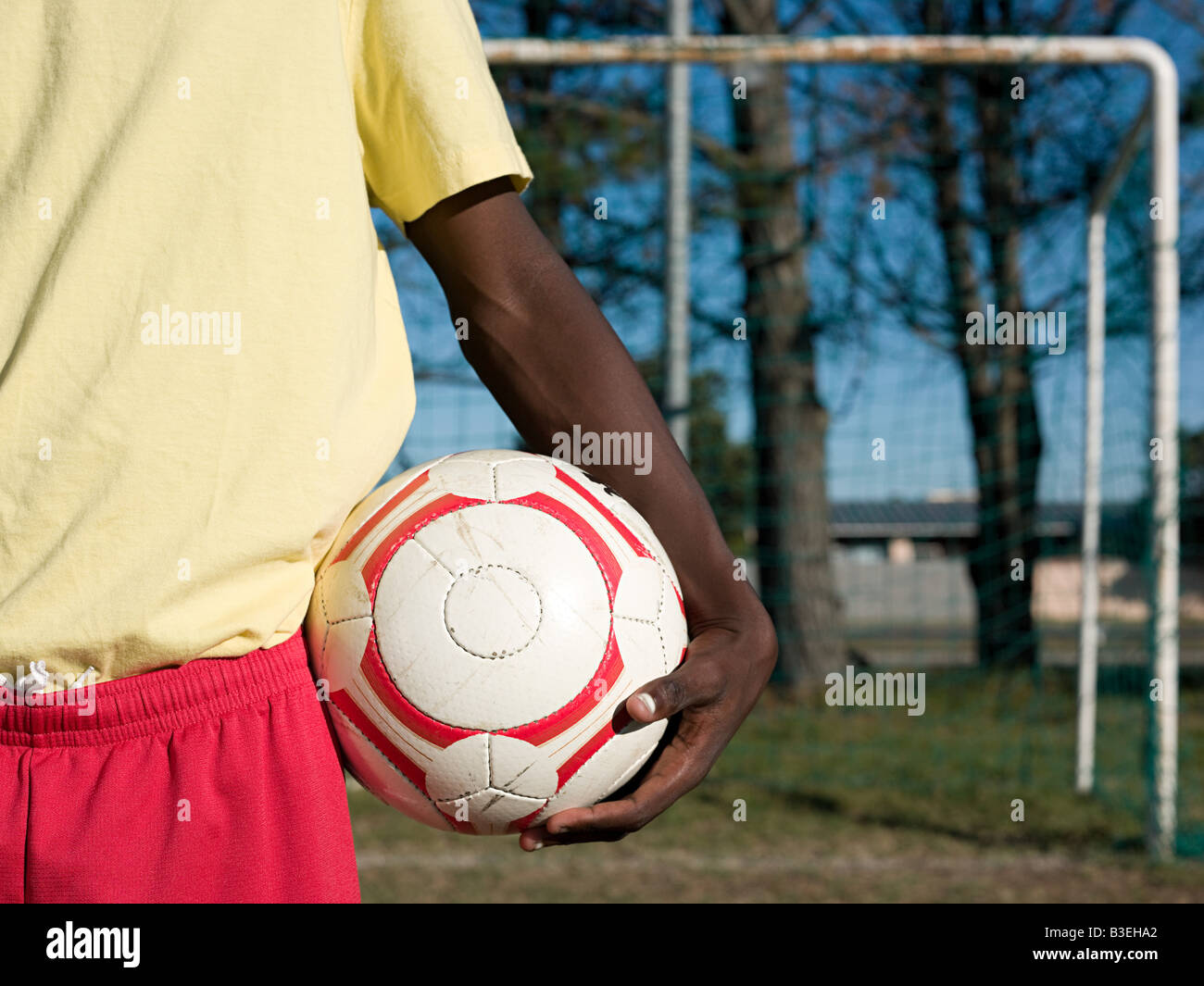 Footballer with a football Stock Photo - Alamy