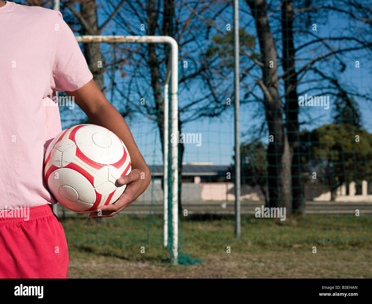 Footballer with a football Stock Photo - Alamy
