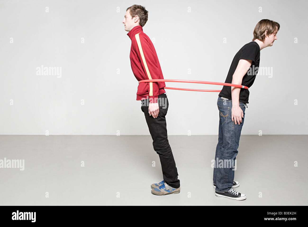 Men pulling plastic hoop Stock Photo - Alamy