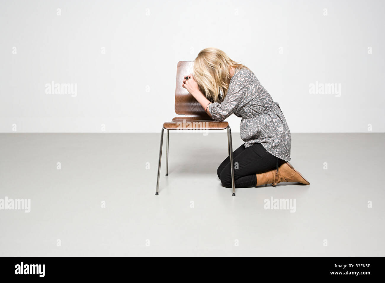 Kneeling woman begging hi-res stock photography and images - Alamy