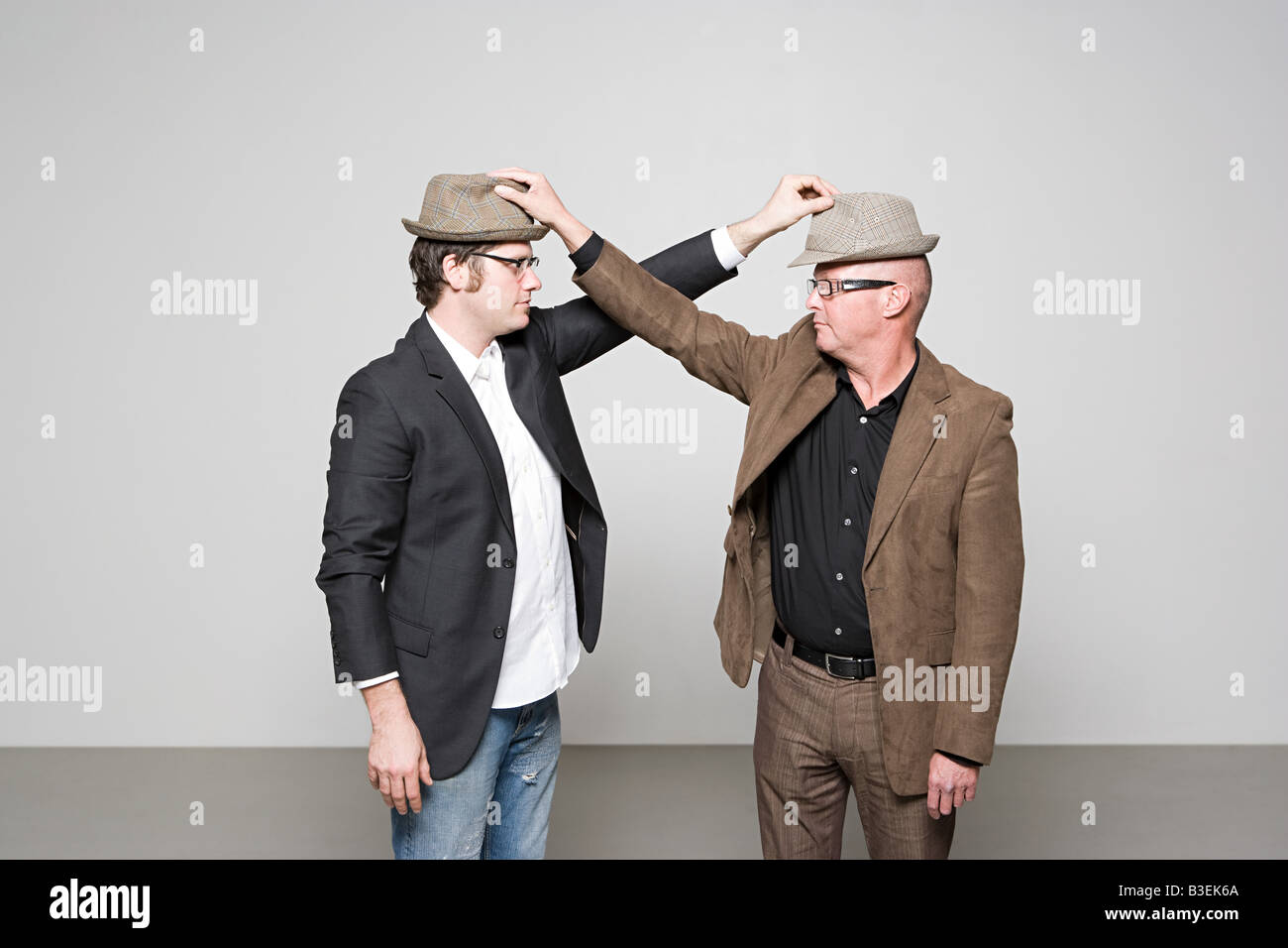 Men holding hats Stock Photo - Alamy