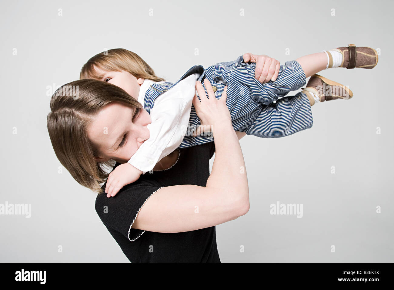 A mother lifting her son Stock Photo - Alamy