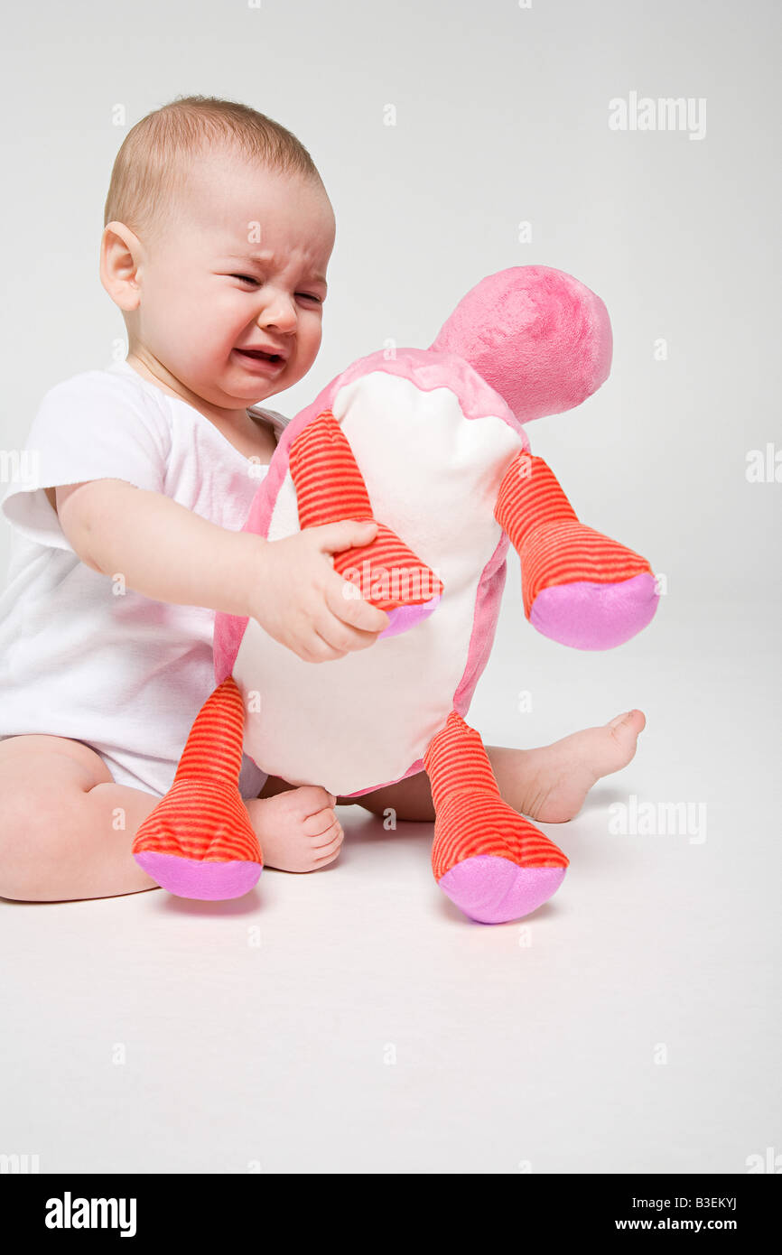 A boy holding a soft toy Stock Photo - Alamy