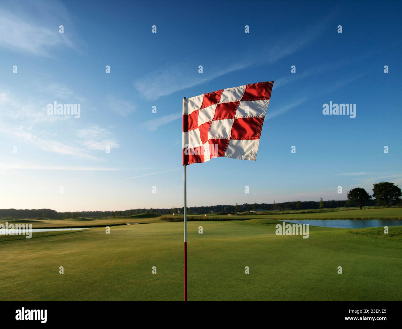 Golf course game hole target goal with red and white chequered flag ...