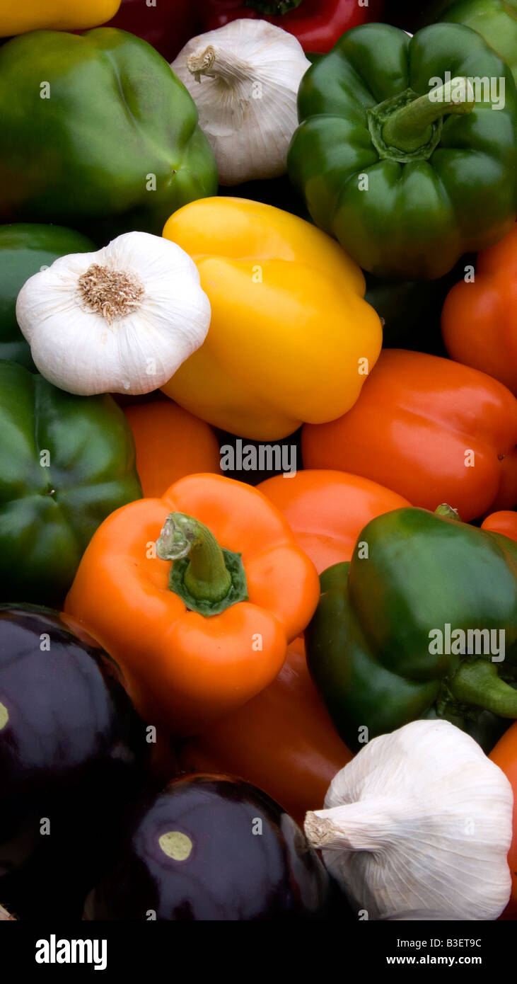 Red Green and Yellow peppers garlic bulbs and Aubergines on market ...