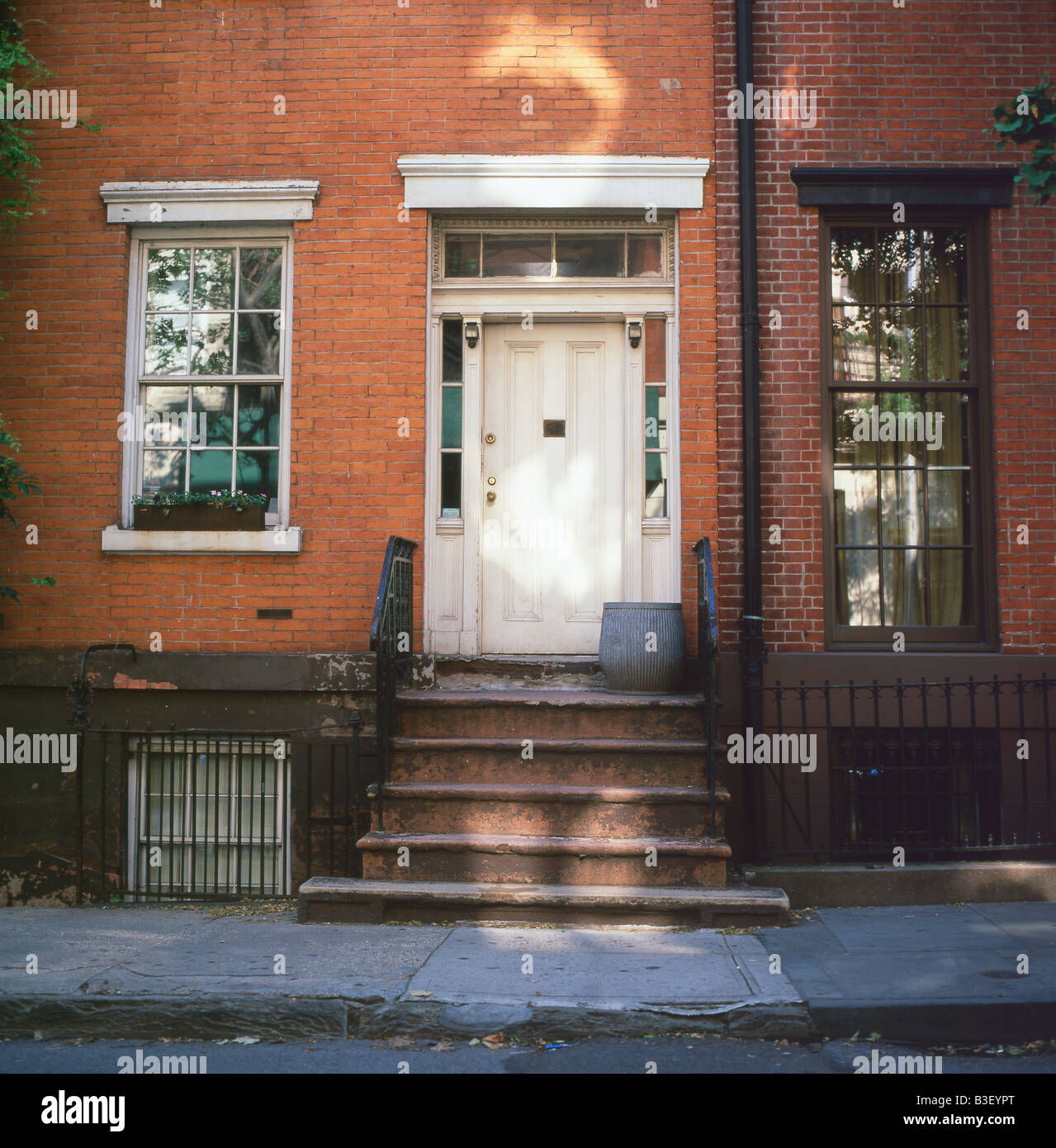 Exterior view of the front door and entrance of a red brick city urban ...