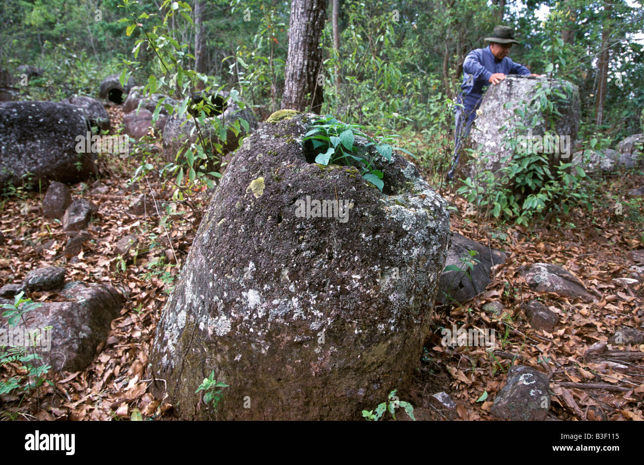 Government official inspects a jar at Ban Phakeo, a jar field ...