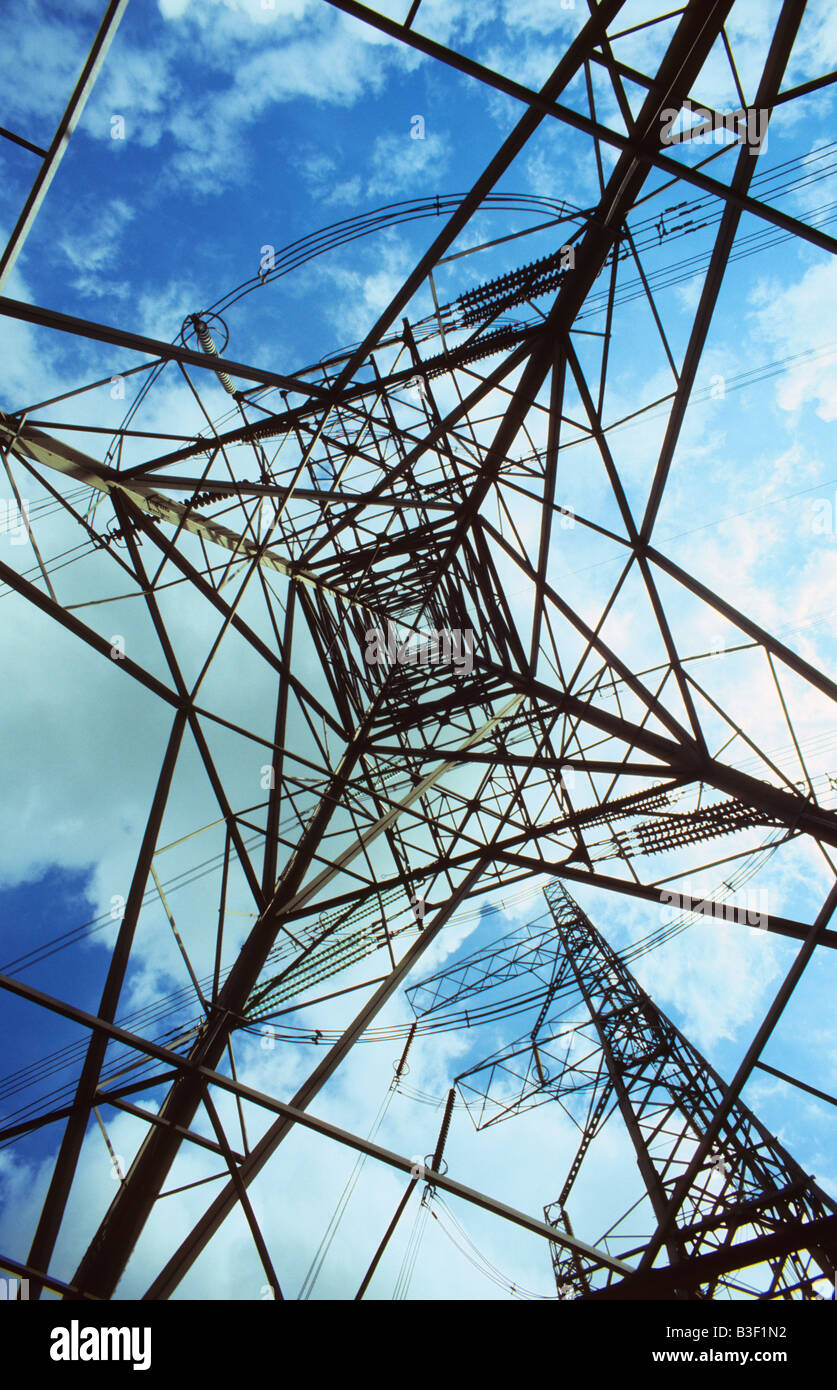 looking straight upwards at giant electricity pylon towering above at ...