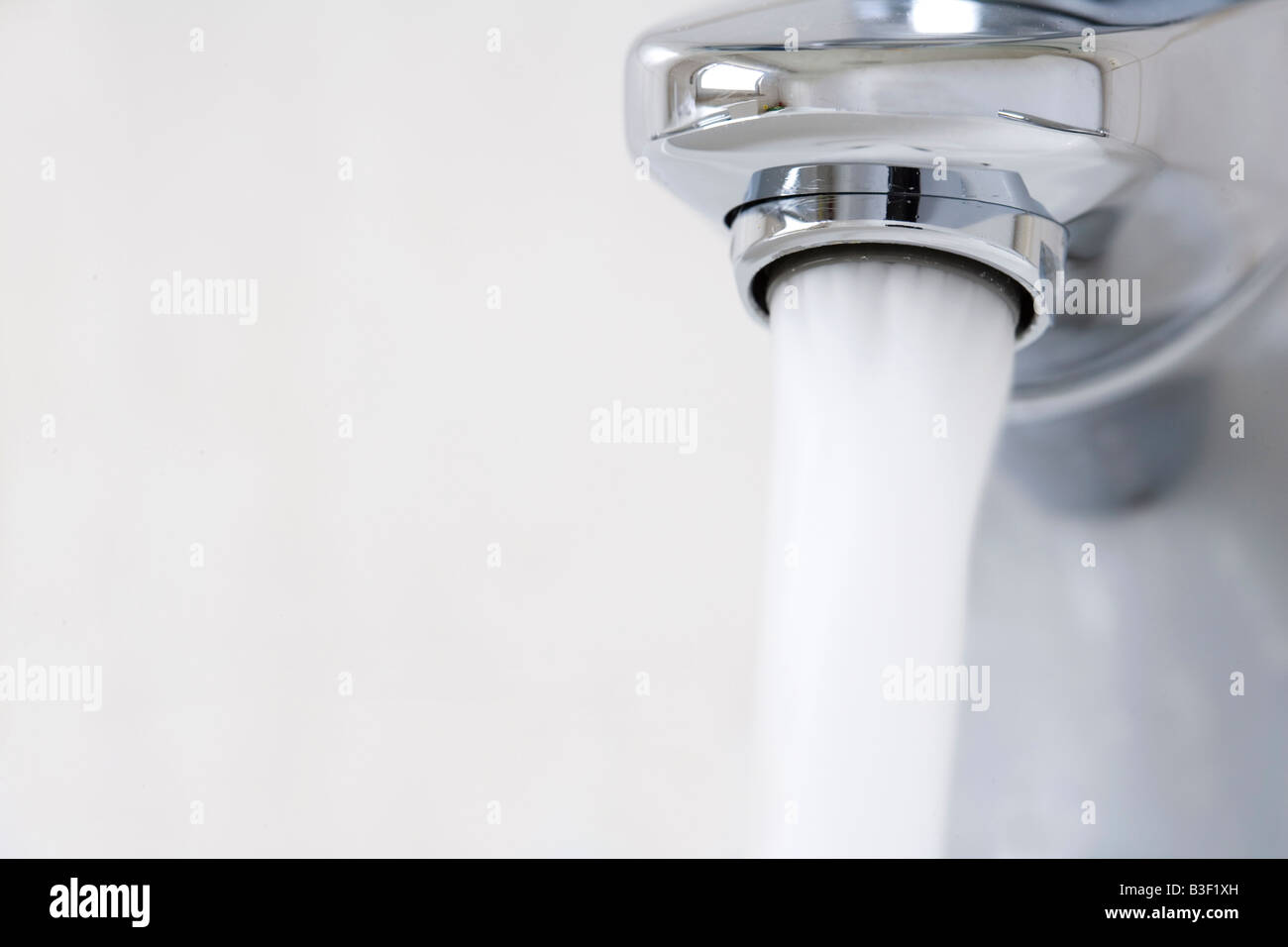 Water flowing out of a water tap Stock Photo - Alamy