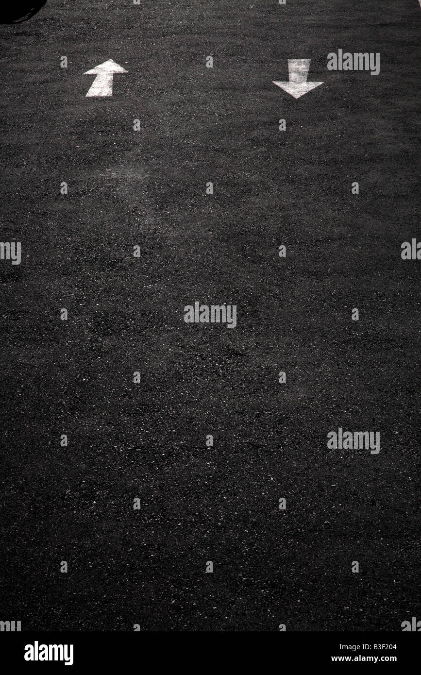 White road direction arrows painted on black tarmac Stock Photo - Alamy White road direction arrows painted on black tarmac Stock Photo - Alamy