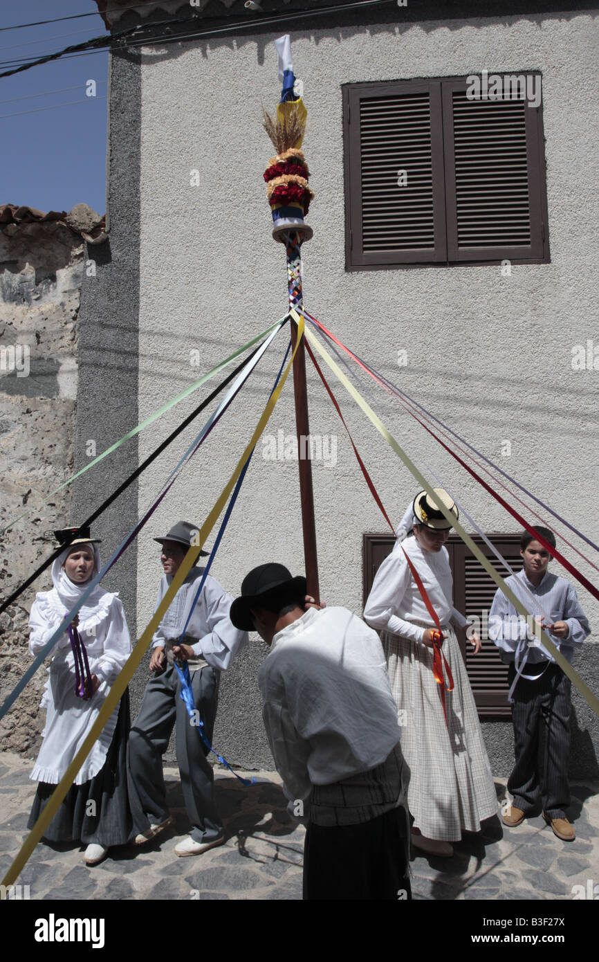 A group of children play a traditional game where they dance around a ...