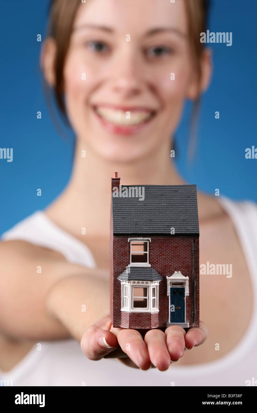 Female holding a model house Stock Photo - Alamy