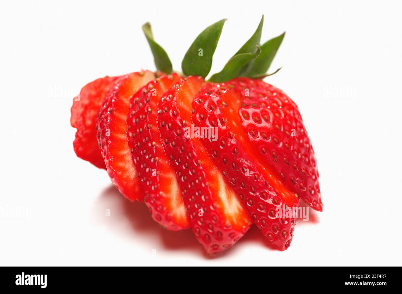 Sliced strawberry on white background Stock Photo - Alamy
