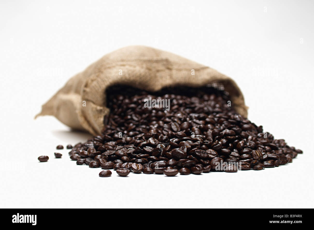 Coffee beans spilling from sack, close-up Stock Photo - Alamy