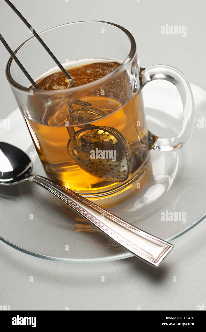 Glass with tea strainer inside, close-up Stock Photo - Alamy