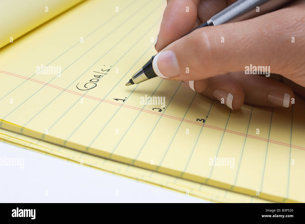 Woman writing list of goals, close-up of hand Stock Photo - Alamy