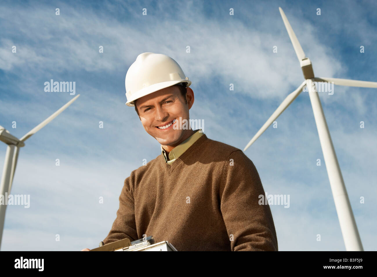 Engineer near wind turbines at wind farm, portrait Stock Photo - Alamy