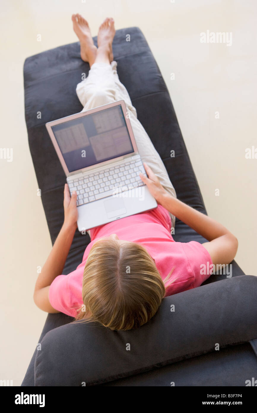 Woman sitting in chair using laptop Stock Photo - Alamy