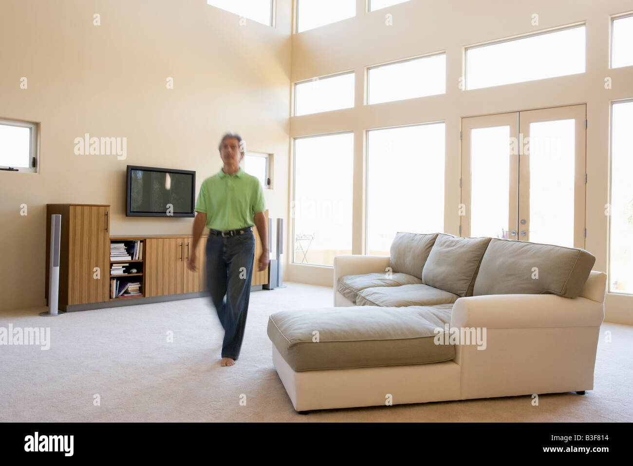 Man walking through room hi-res stock photography and images - Alamy