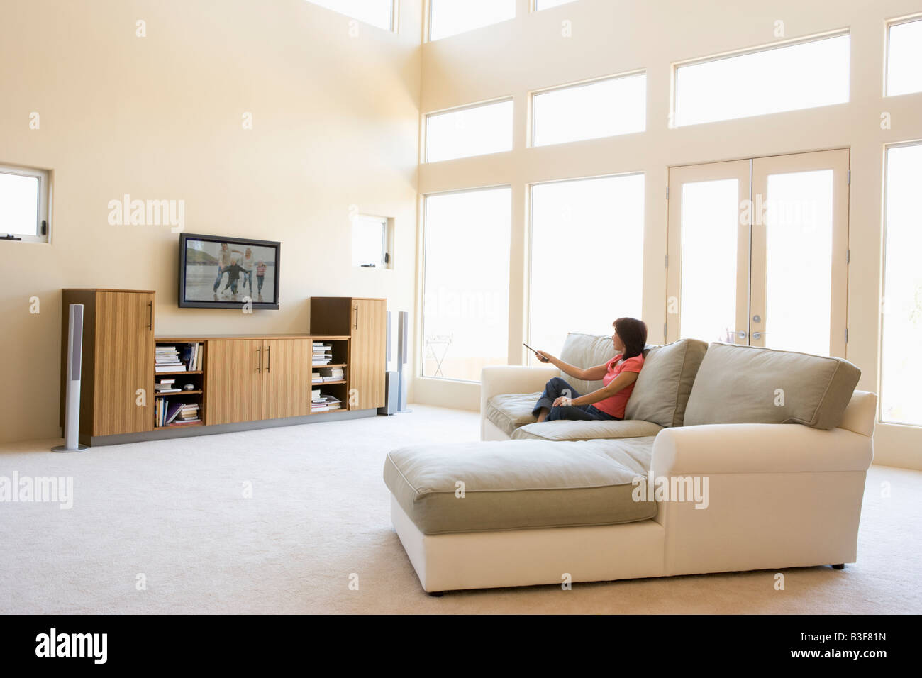 Woman in living room watching television Stock Photo - Alamy