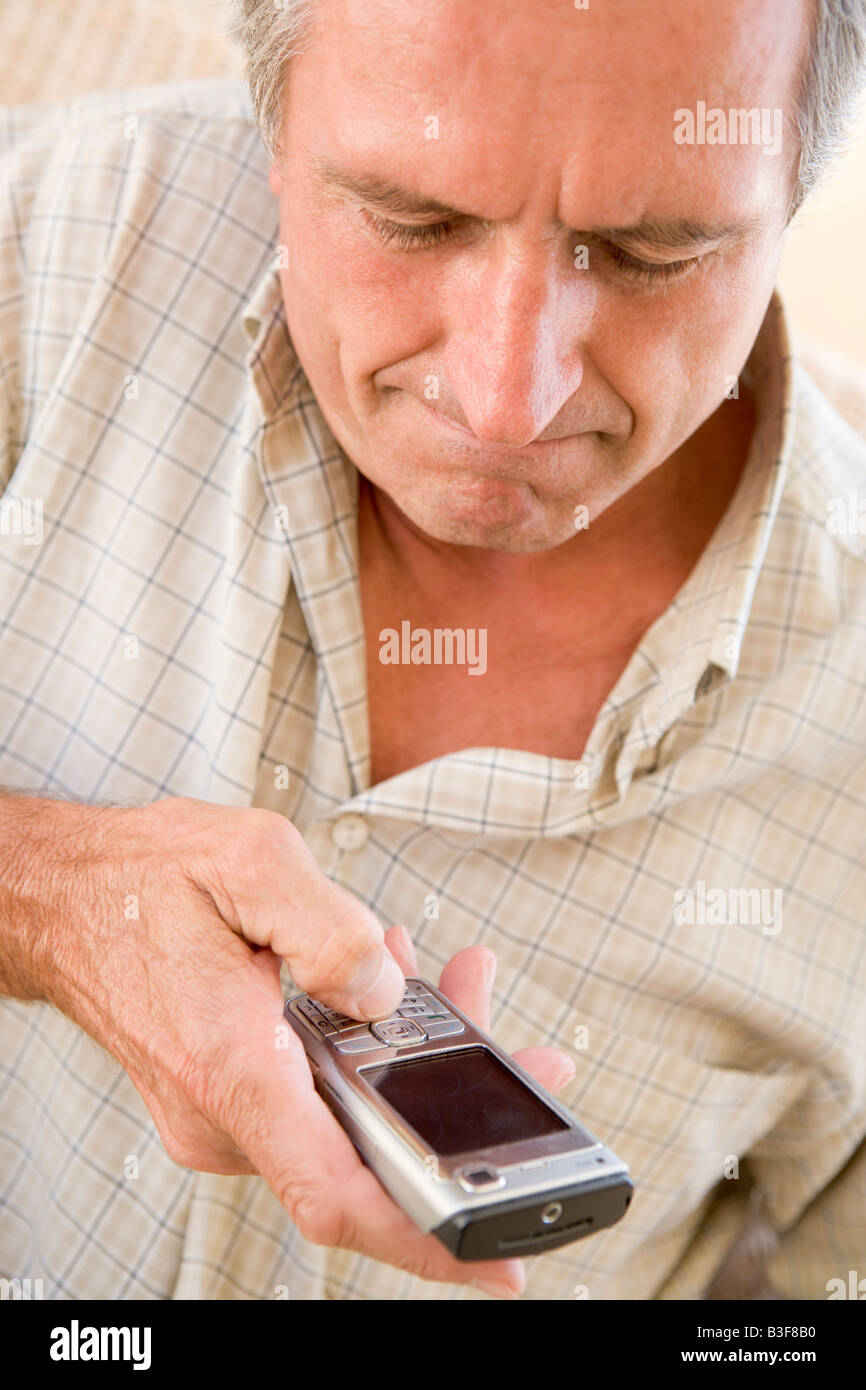 Man using cellular phone indoors Stock Photo - Alamy