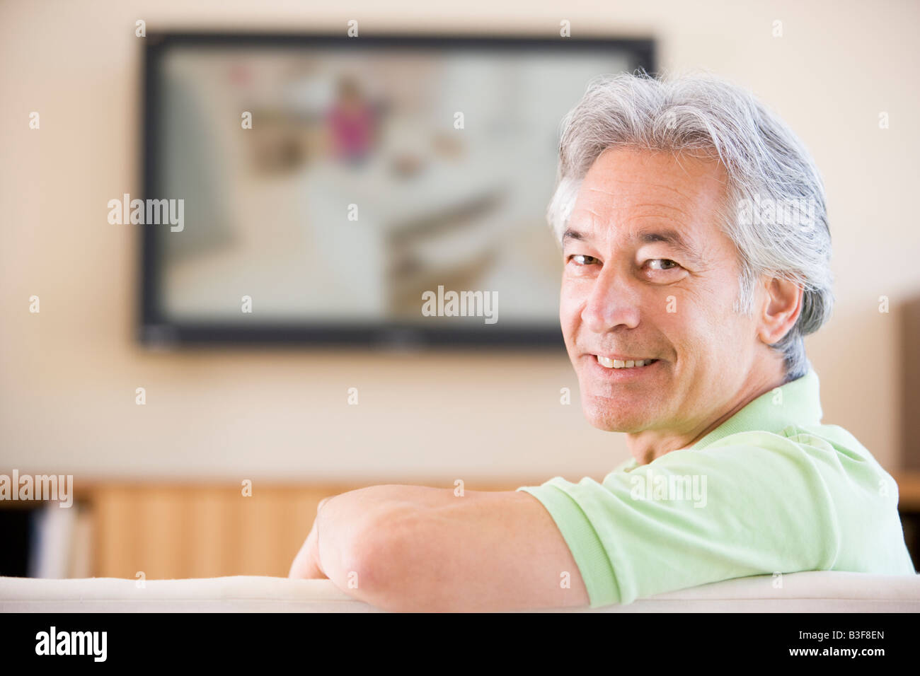 Man watching television smiling Stock Photo - Alamy