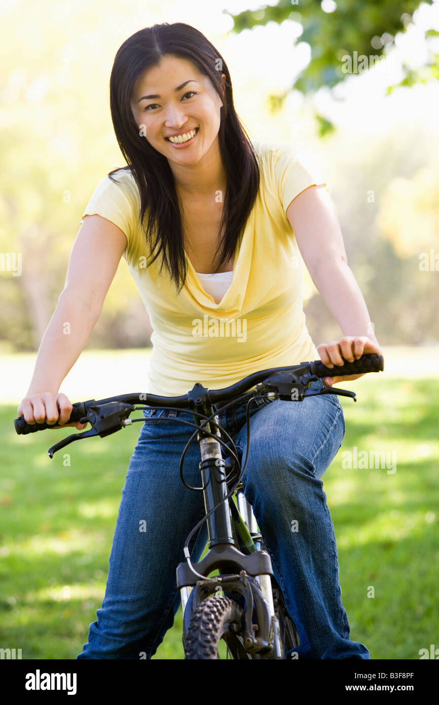 Woman on bicycle smiling Stock Photo - Alamy