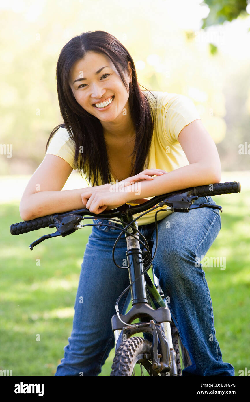 Woman on bicycle smiling Stock Photo - Alamy