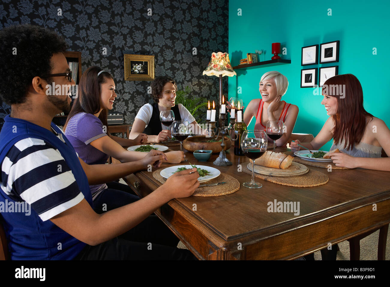Group of people sitting at dining table Stock Photo - Alamy