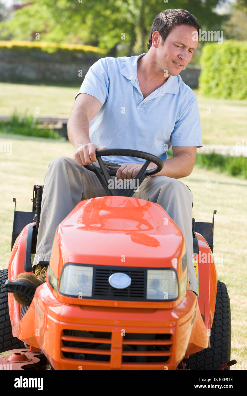 Man sitting on lawn mower hi-res stock photography and images - Alamy