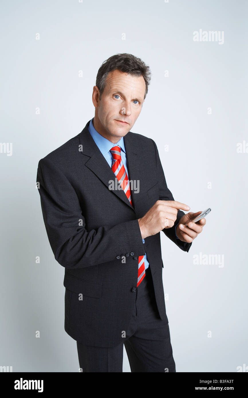 Studio shot of businessman text messaging Stock Photo - Alamy
