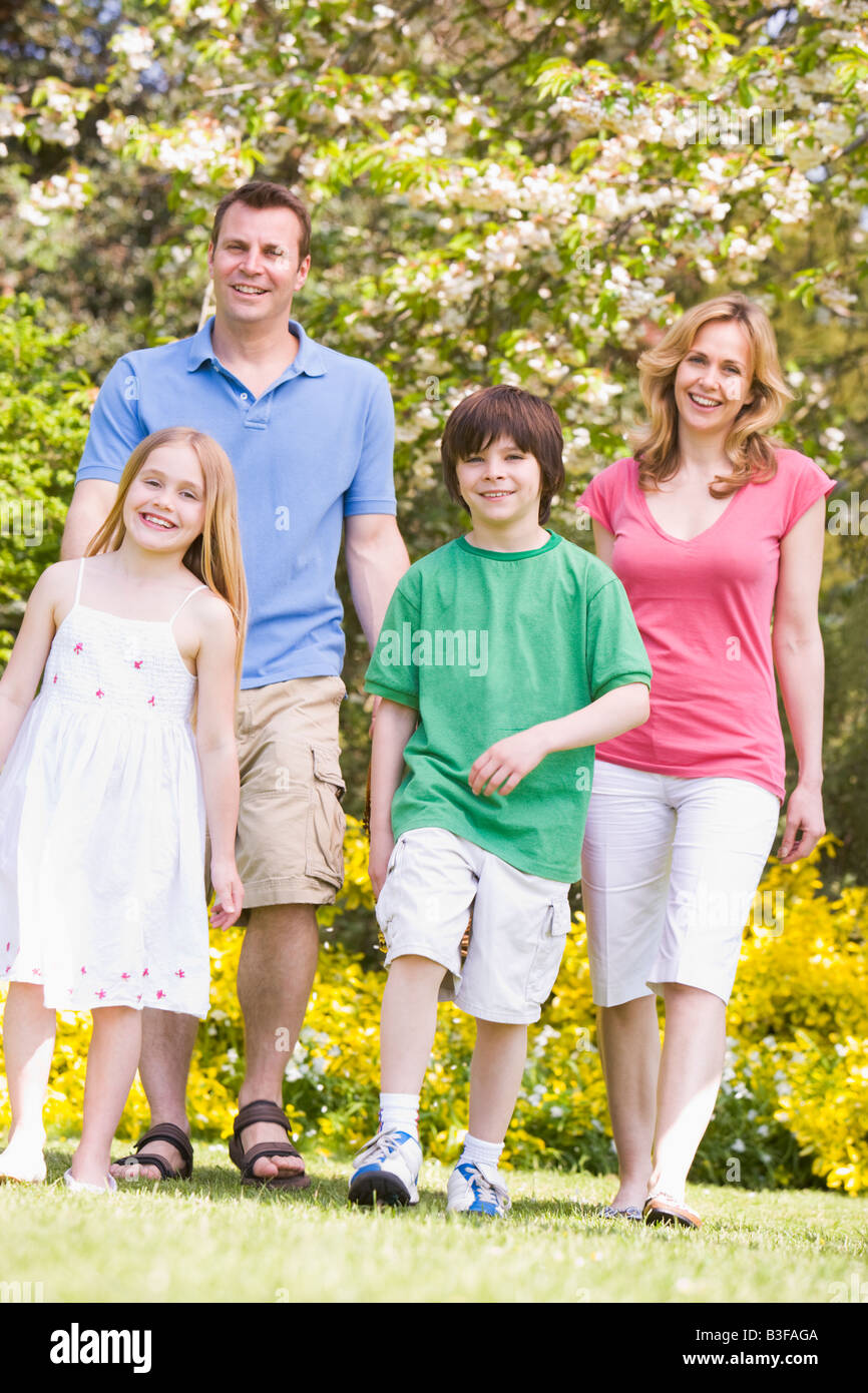 Family walking outdoors smiling Stock Photo - Alamy