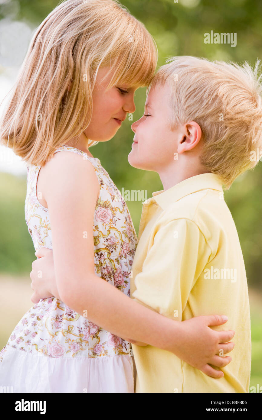 Two young children hugging outdoors Stock Photo - Alamy