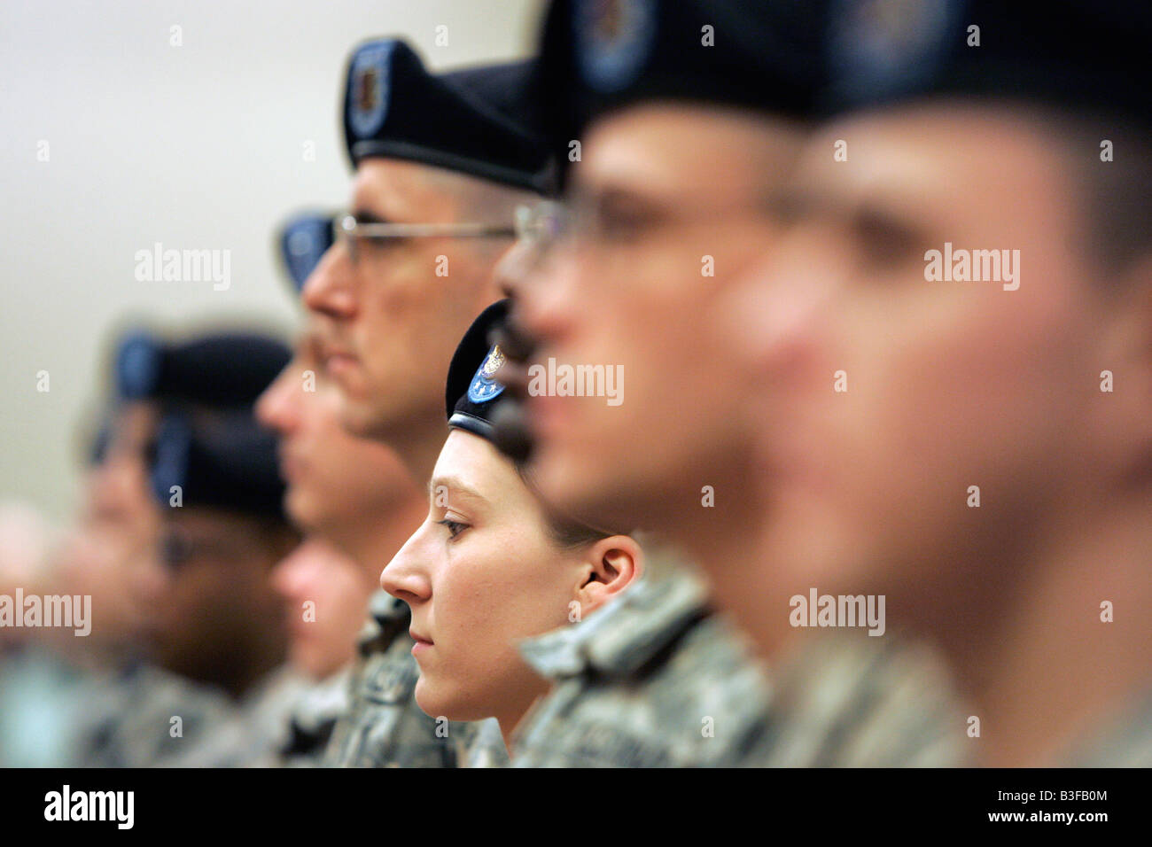 A female soldier stands at attention in formation during a military ...