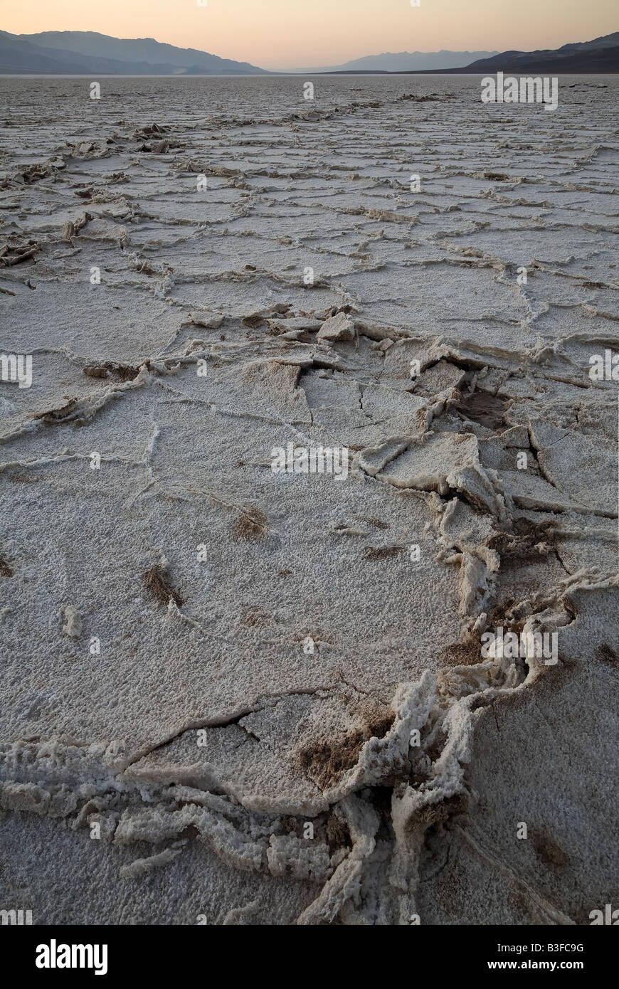 Cracked salt form a rift into the sunset, Death Valley Stock Photo - Alamy