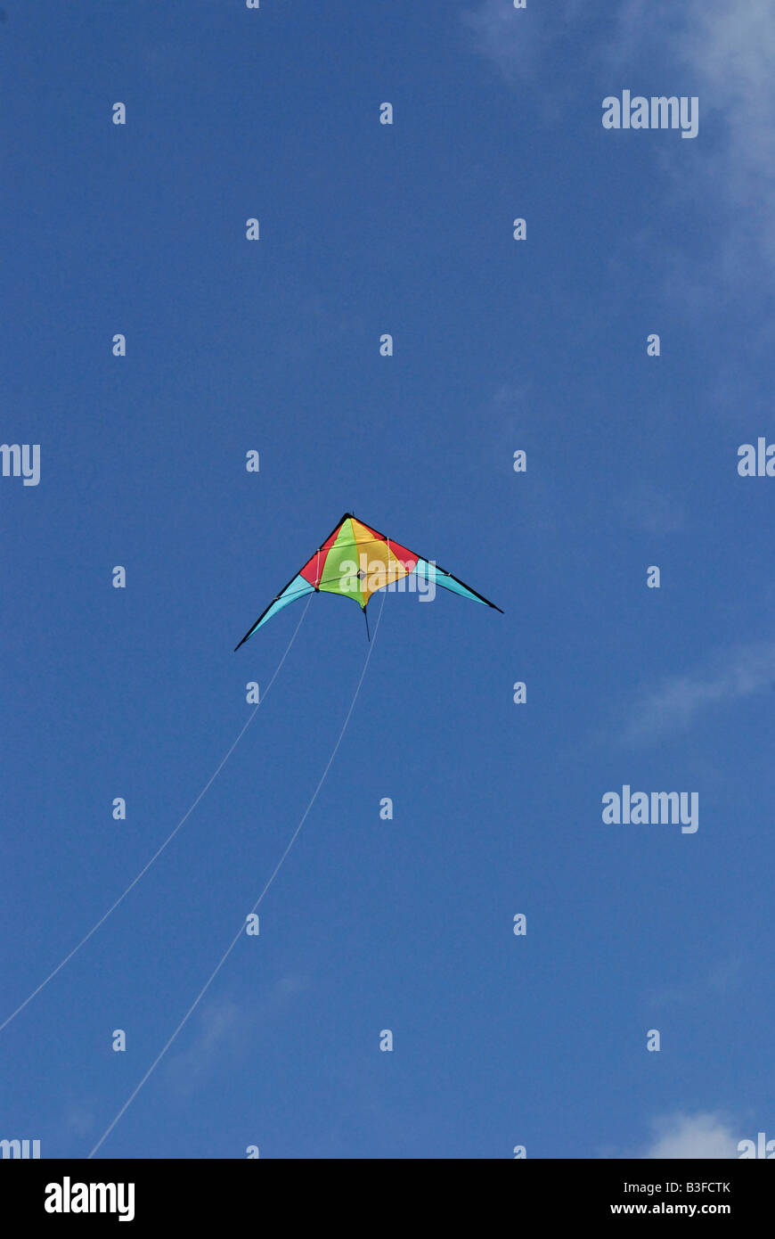 upright of a colourful stunt kite flying in a blue sky Stock Photo - Alamy