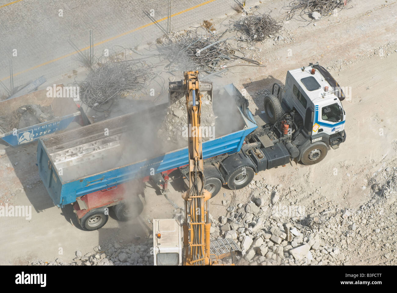 crawler bucket excavator loading semi-trailer truck Stock Photo - Alamy