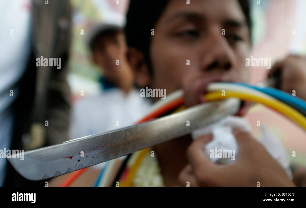 Blood is seen on the blade of the sword piercing a man's cheek at ...