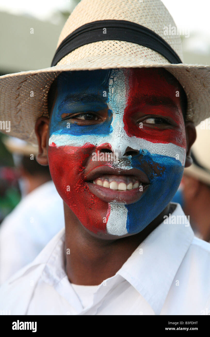 Carnival participant with Dominican flag on his face performing during ...