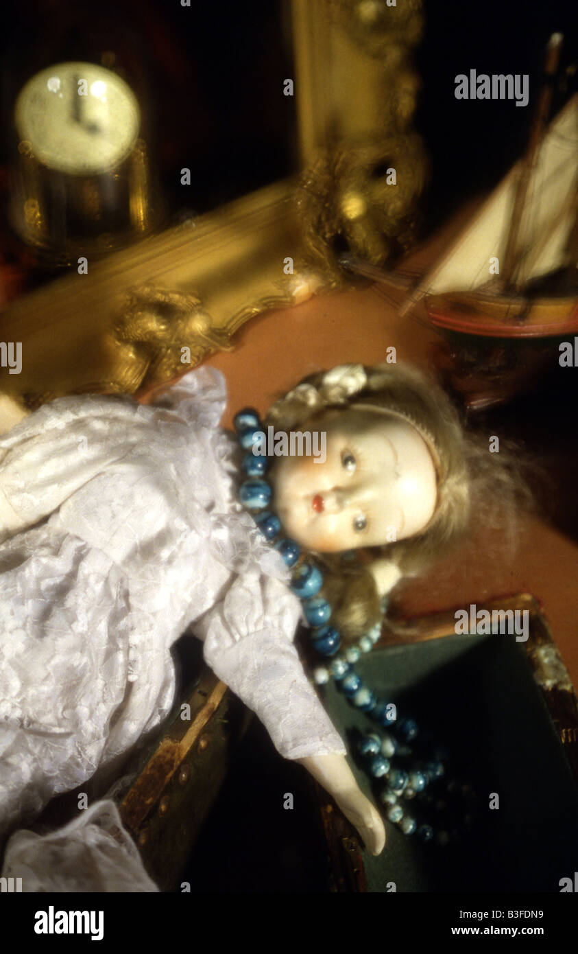 still life with antiques; clock, doll, ship, wood frame Stock Photo - Alamy