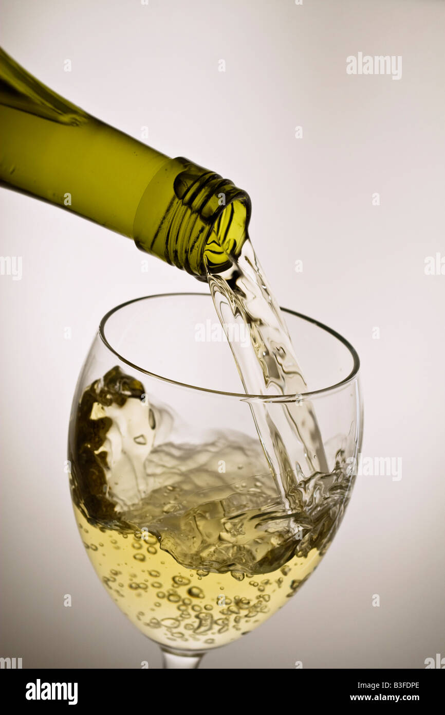 white wine poured in glass Stock Photo - Alamy