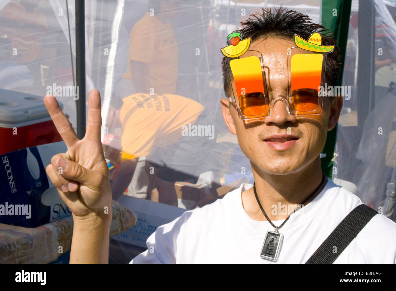 Hmong man age 21 wears island sun glasses gives peace symbol. Hmong ...