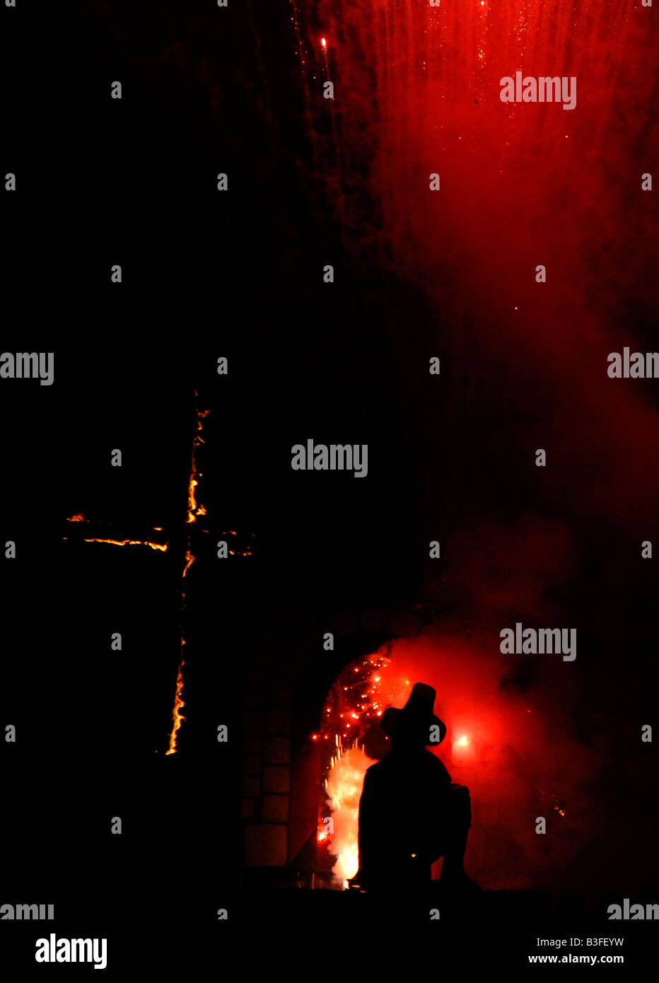 A cross and effigy of Guy Fawkes burns at the Cliffe bonfire society ...