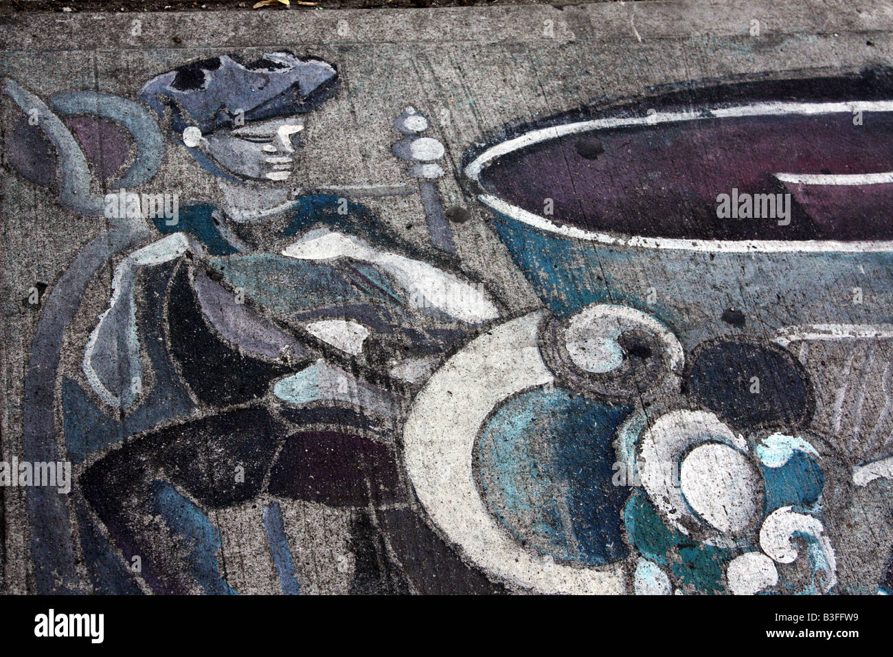 Fading graffiti jester or clown on cement pavement of Queen Street West ...