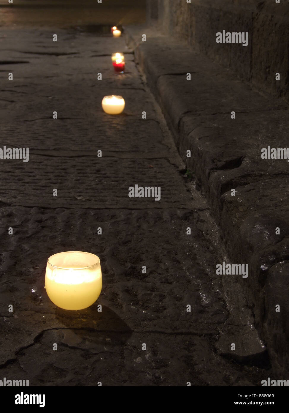 row of candles outdoors at night Stock Photo - Alamy